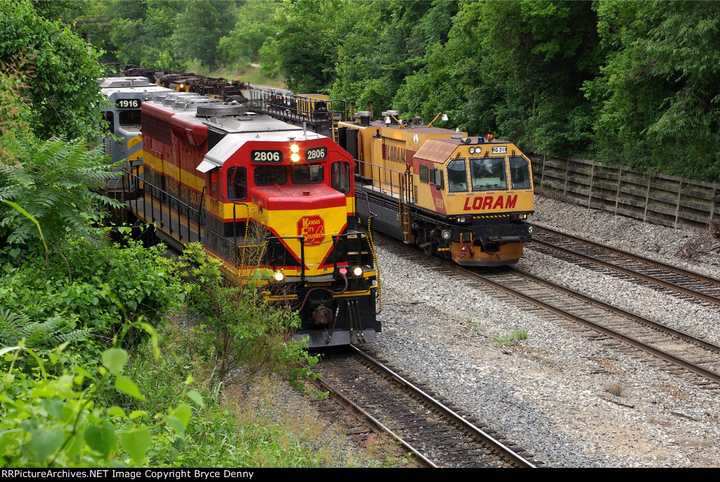 KCS 2806 going downgrade into the Texas Avenue cut past LORAM rail grinding train
